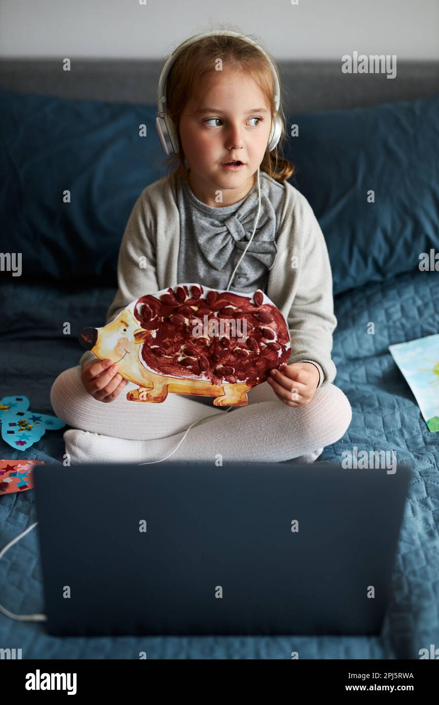 Little girl preschooler learning online showing her works drawings done ...