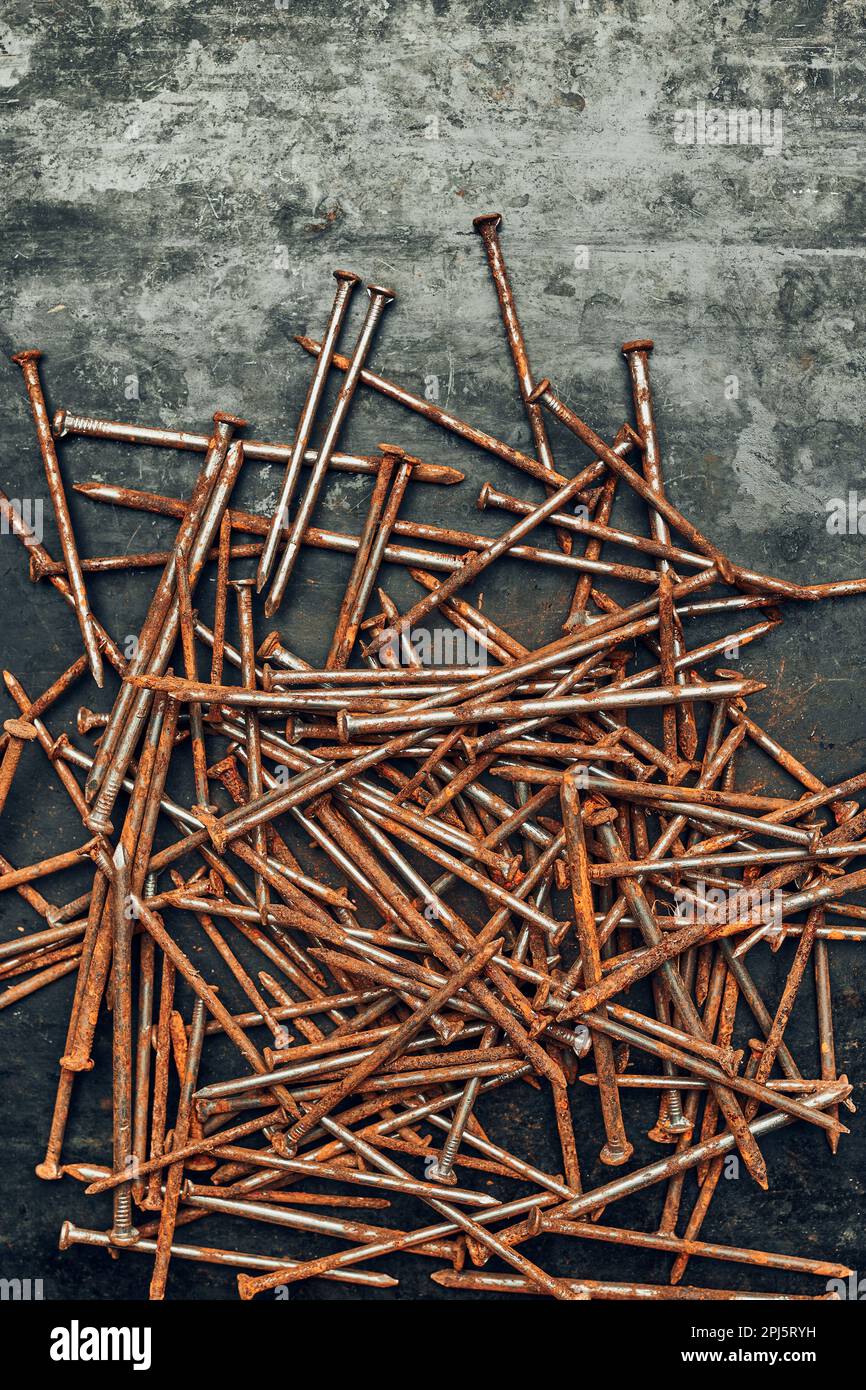 Rusty nails on steel surface. Tools for maintenance. Hardware tools to ...