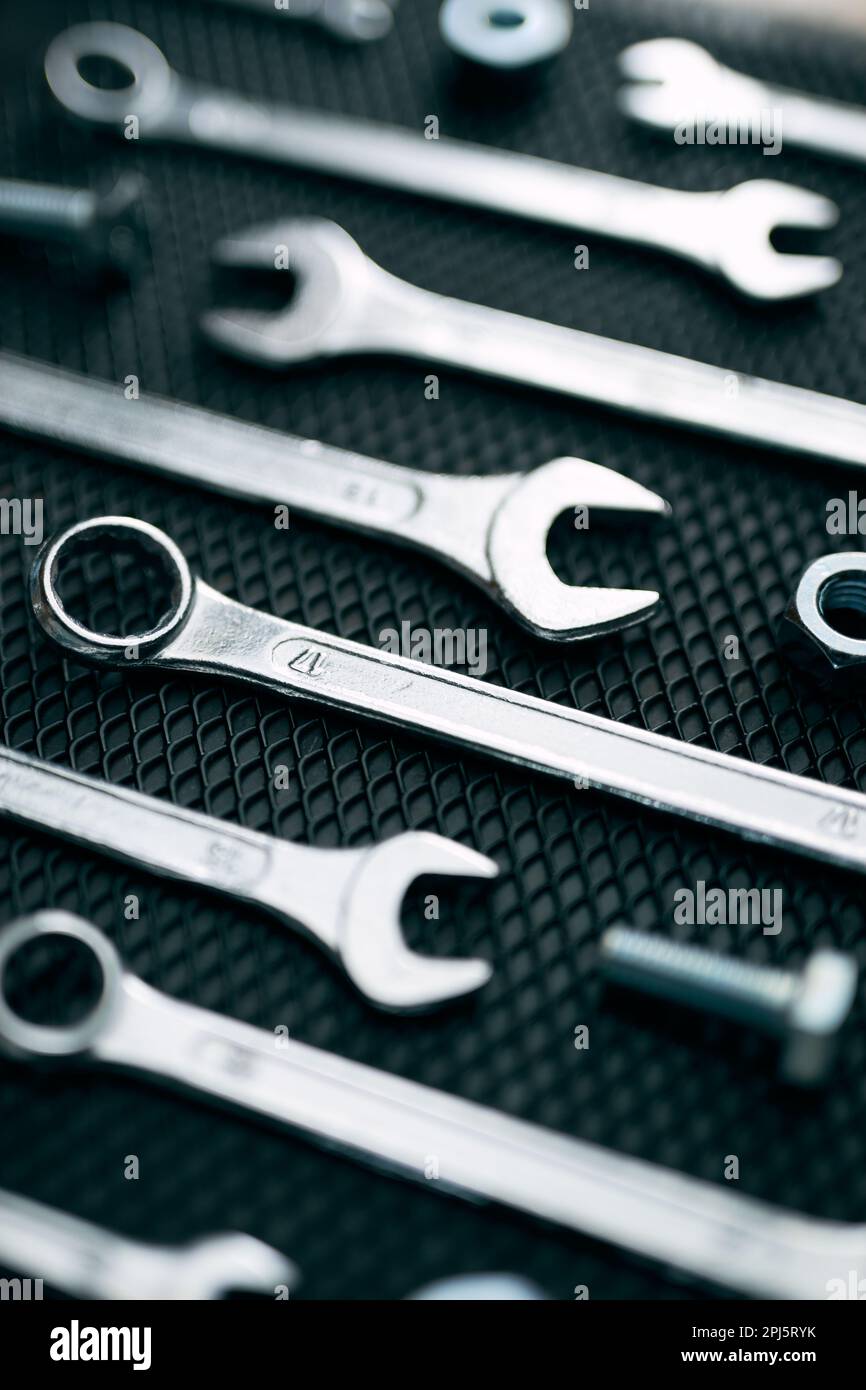 Set of chrome wrenches on steel surface. Mechanic tools for maintenance ...