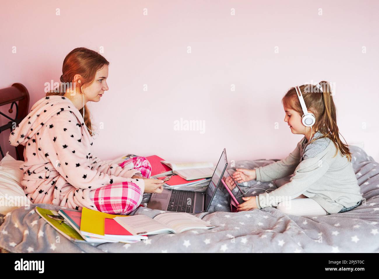 Student learning online, watching lesson remotely, listening to ...