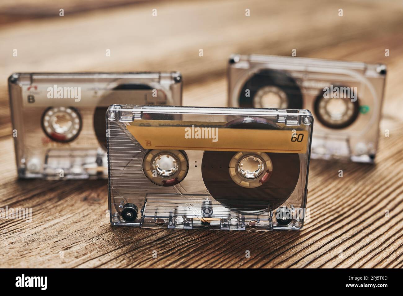 Tape cassettes. Magnetic cassette tapes on wooden table. Retro music ...