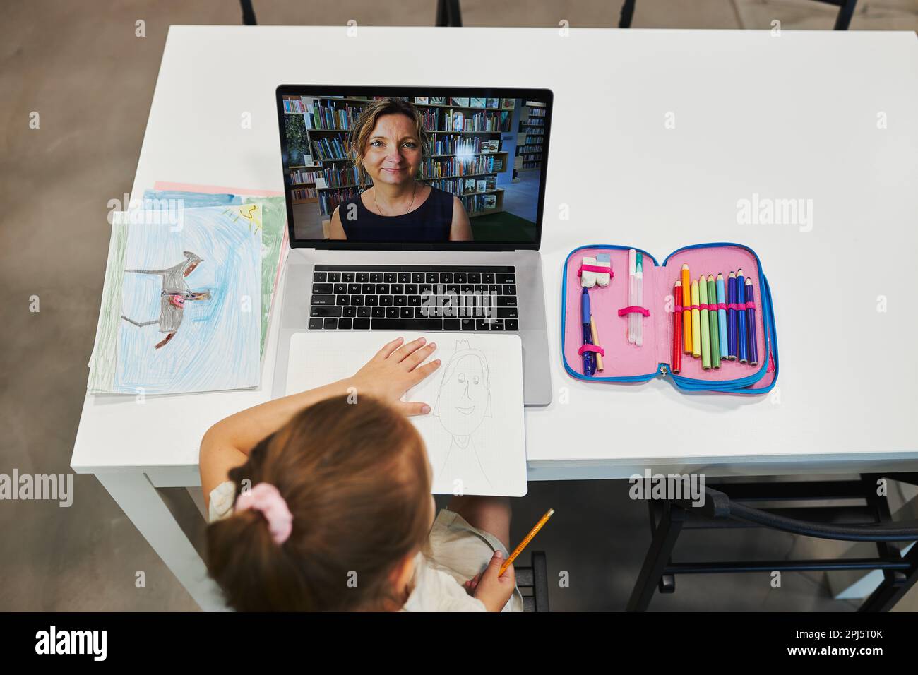 Student litttle girl having video class remotely with her teacher on ...