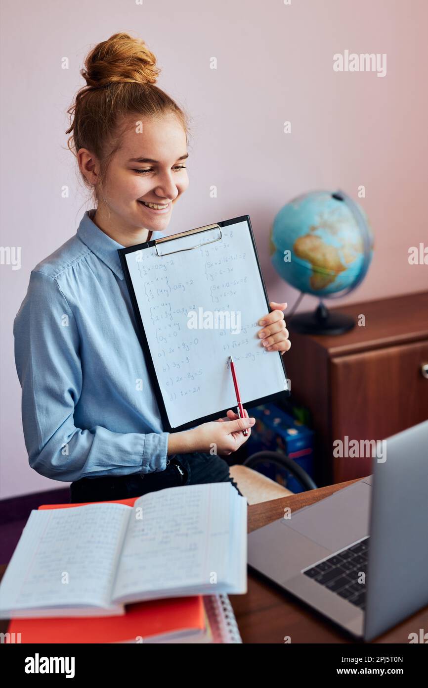 Young woman student showing homework, having classes, learning online ...