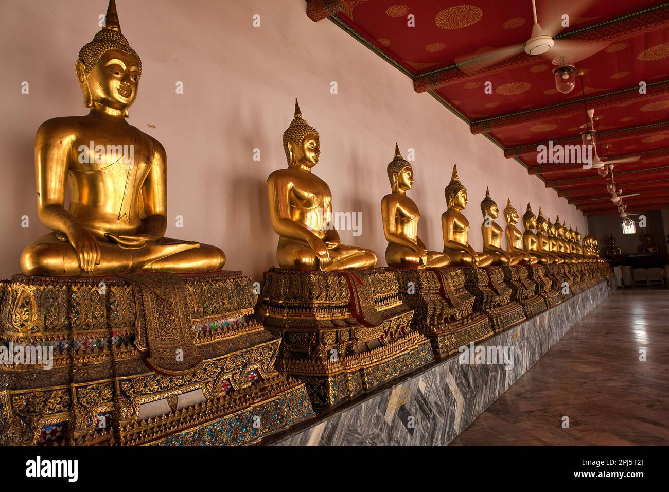 Golden Buddha figures along a corridor at Wat Pho temple in Bangok ...