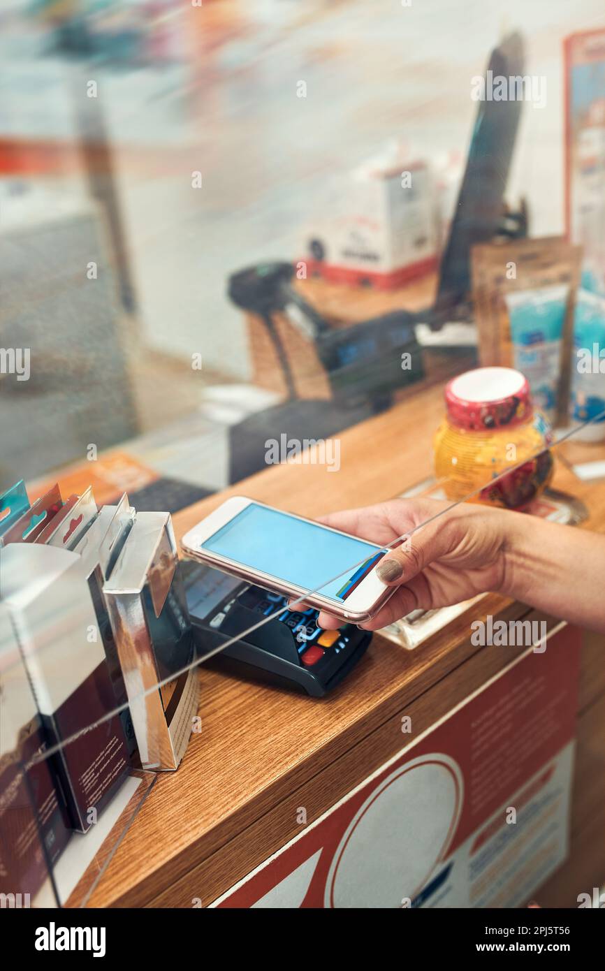 Woman paying for medicines at pharmacy using contactless method of ...
