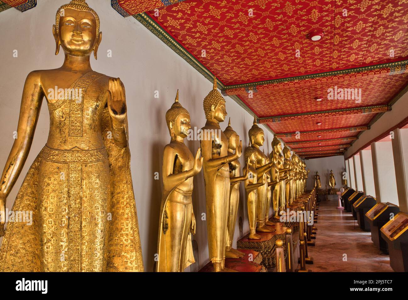 Golden Buddha figures along a corridor at Wat Pho temple in Bangok ...