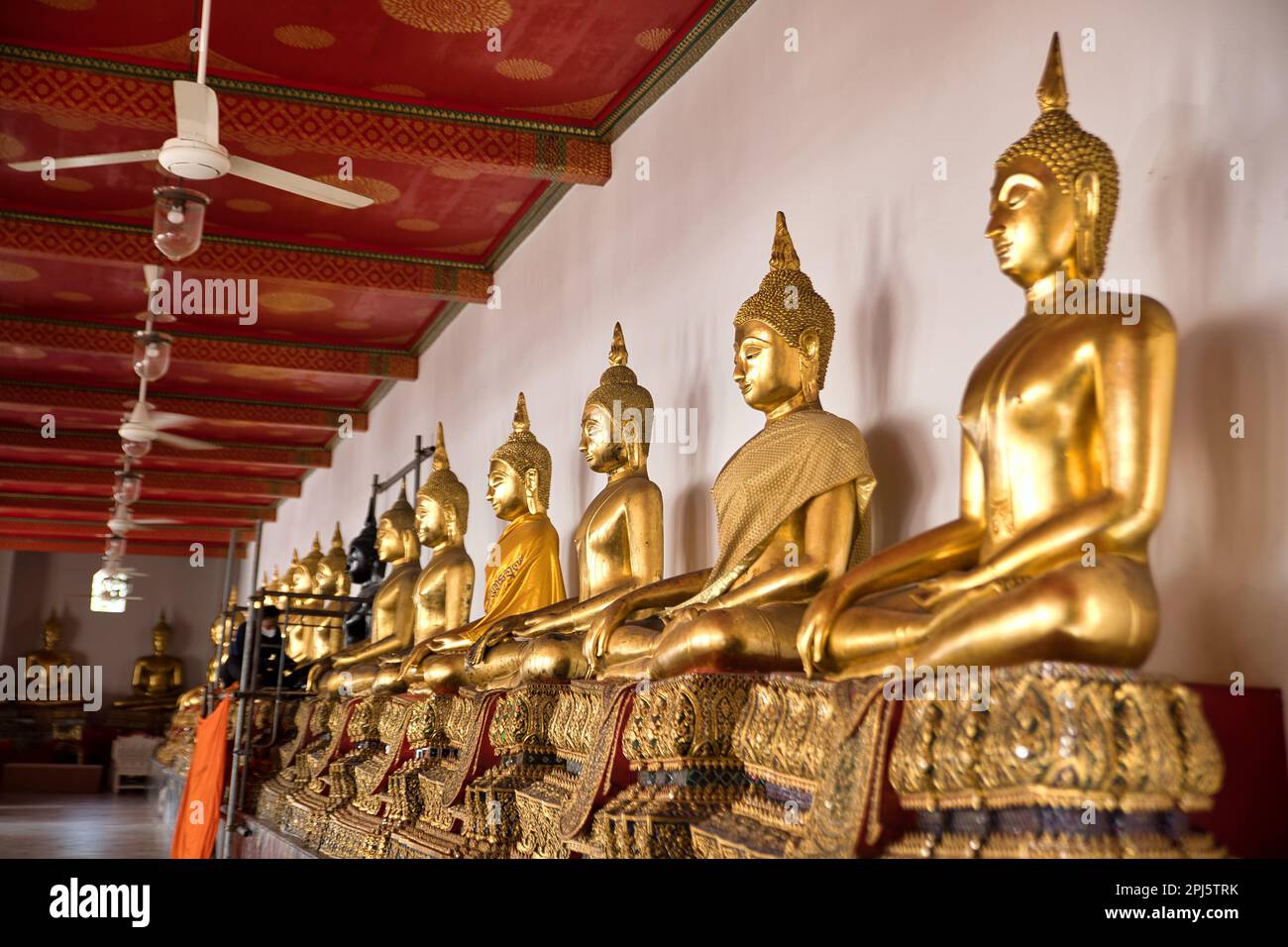 Golden Buddha figures along a corridor at Wat Pho temple in Bangok ...