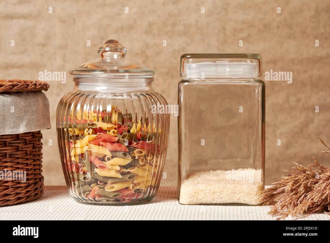 Decorative containers for food grain, rice and colored pasta on the ...