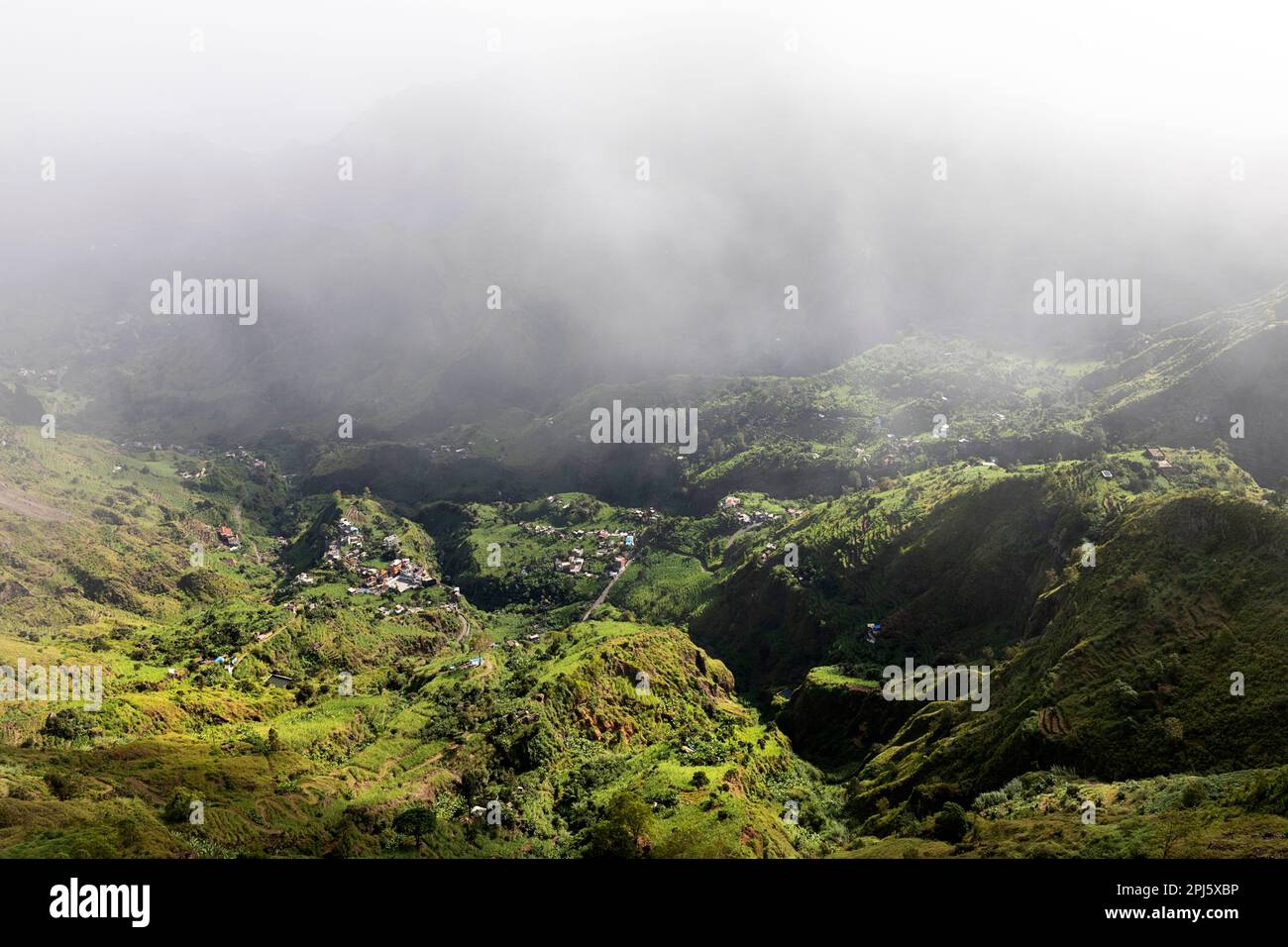 Spectacular green valley with small traditional village in morning ...
