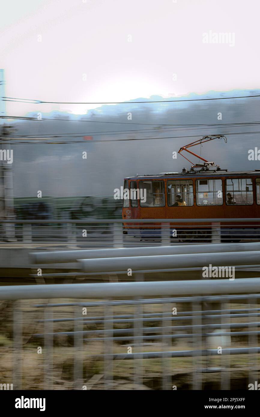 A vintage train chugging down railway tracks in a vast landscape, with ...