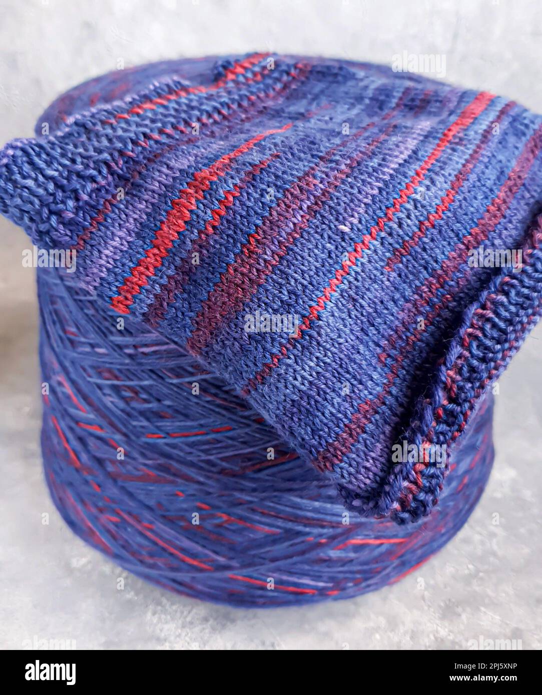 Handmade knitting pattern. Knitted fabric from a multi-colored thread ...