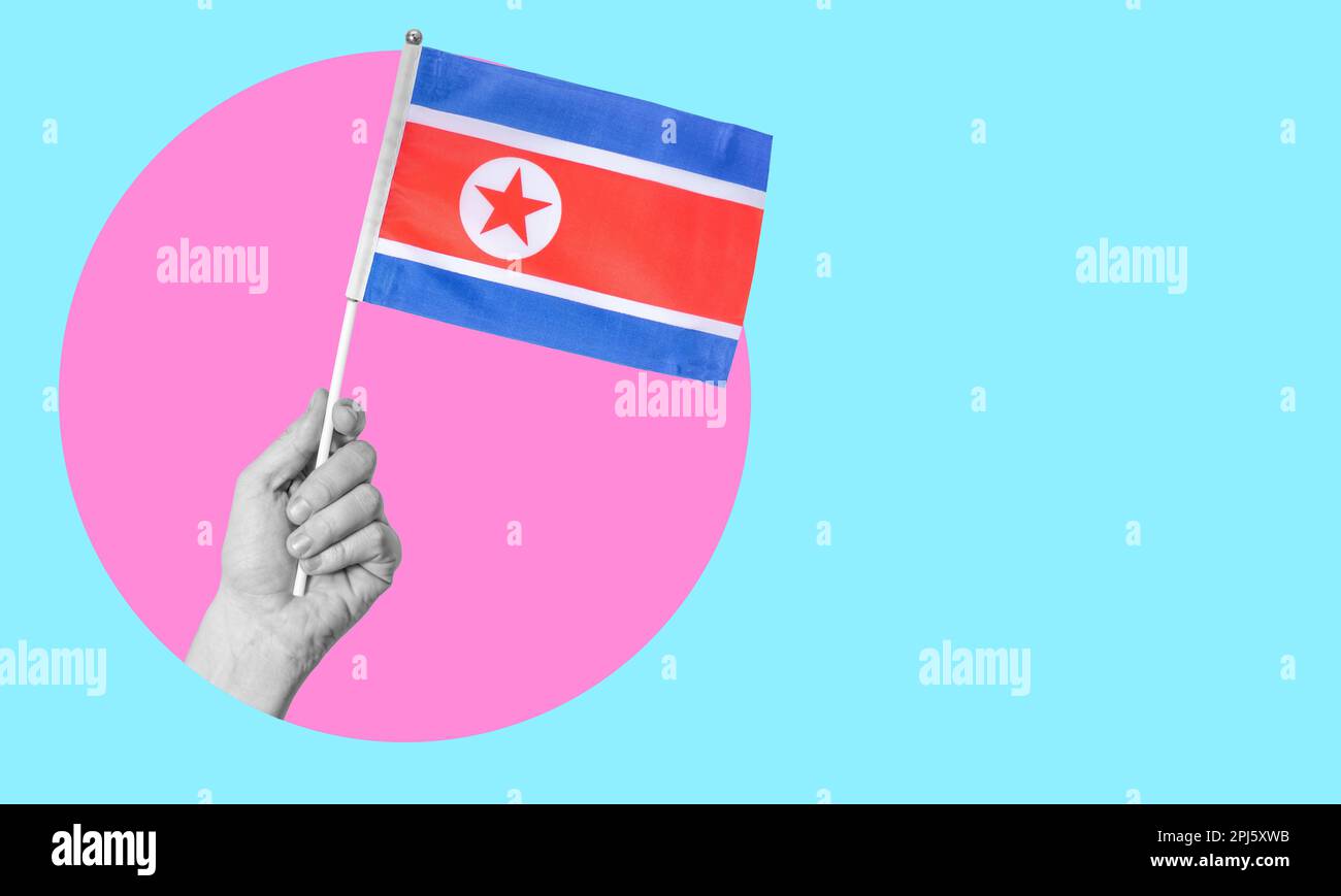 A collage of modern art. Female hand holding DPRK flag in a circle ...