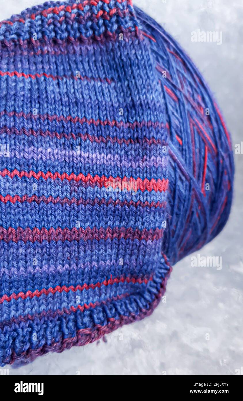 Handmade knitting pattern. Knitted fabric from a multi-colored thread ...