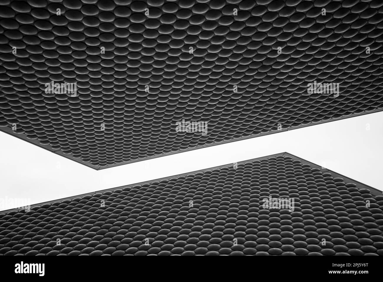 A minimalist architectural backdrop featuring two diagonal buildings in ...