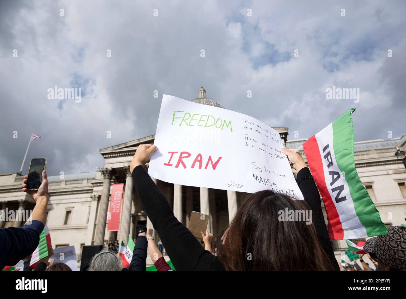Posters, flags and messages are held as participants gather in support ...
