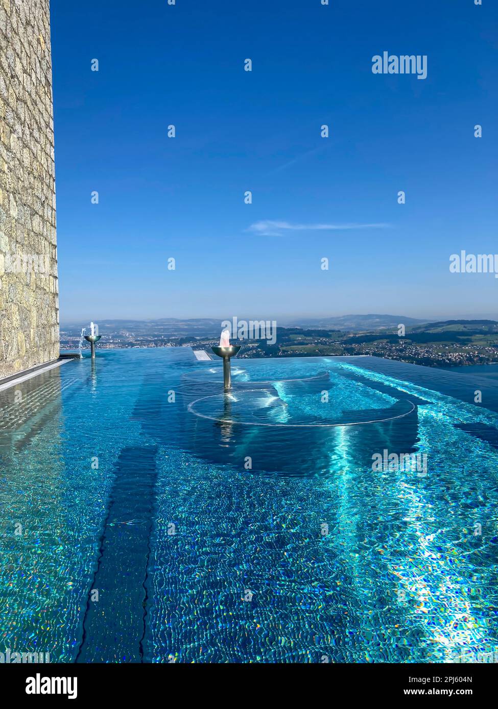 Infinity Swimming Pool with Mountain and Lake Lucerne View in a Sunny ...