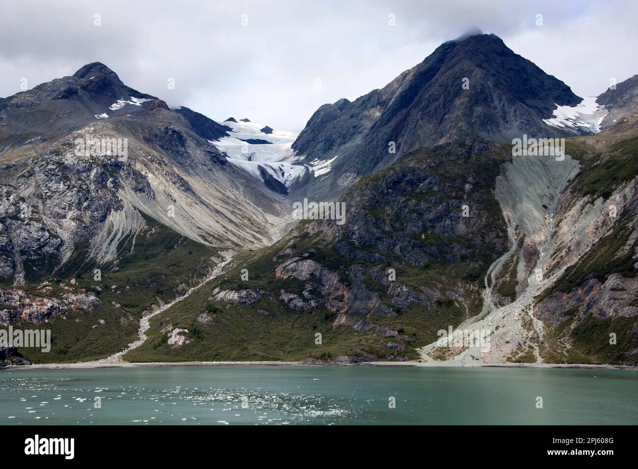 The Summer view of icy waters and steet colorful mountains in Glacier ...