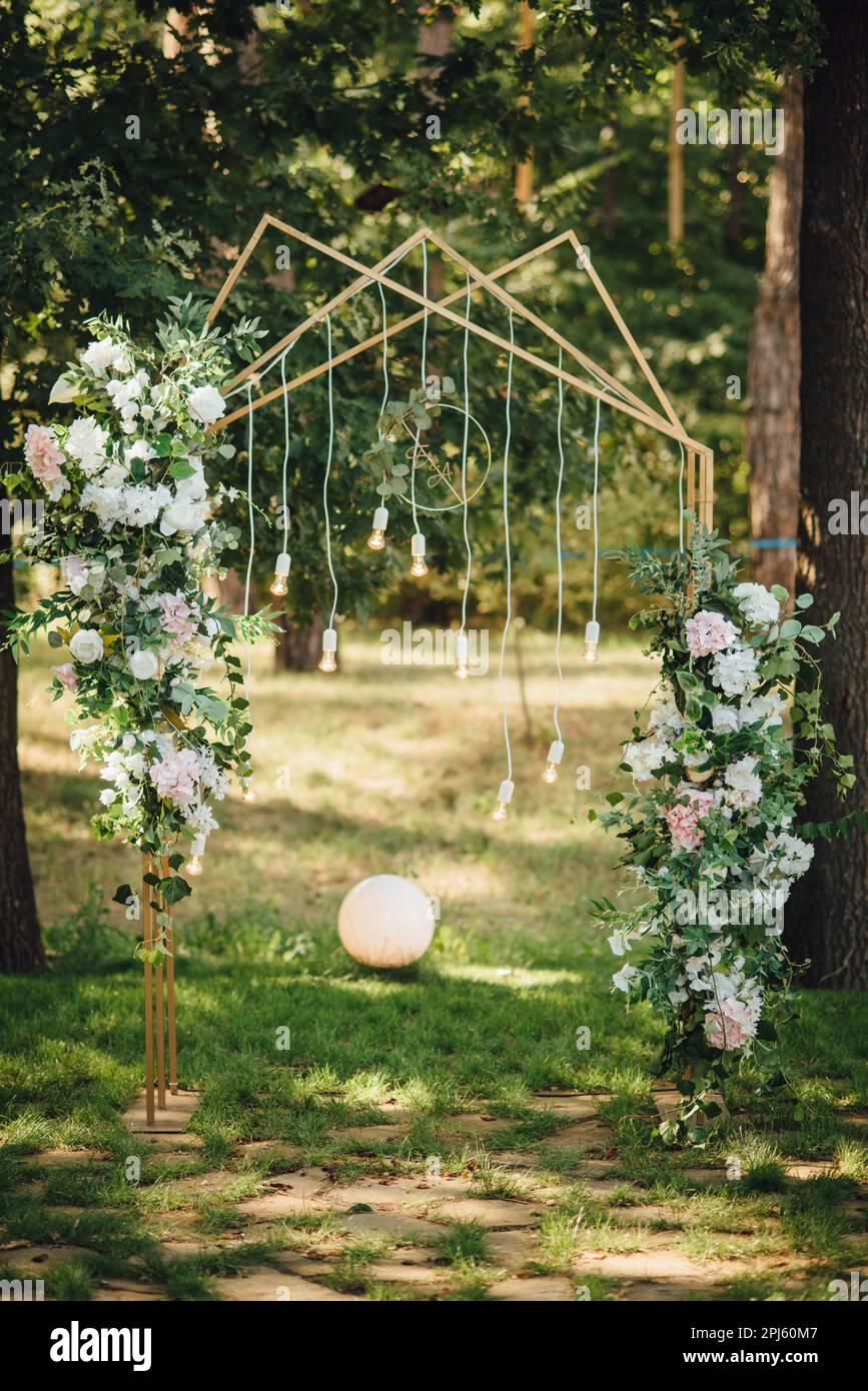 A beautiful archway adorned with vibrant floral arrangements, lush ...