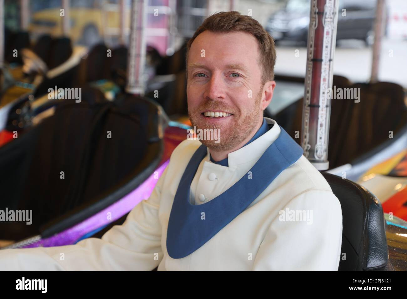 Erfurt, Germany. 31st Mar, 2023. Pastor Klaus Zebe sits in a bumper car ...