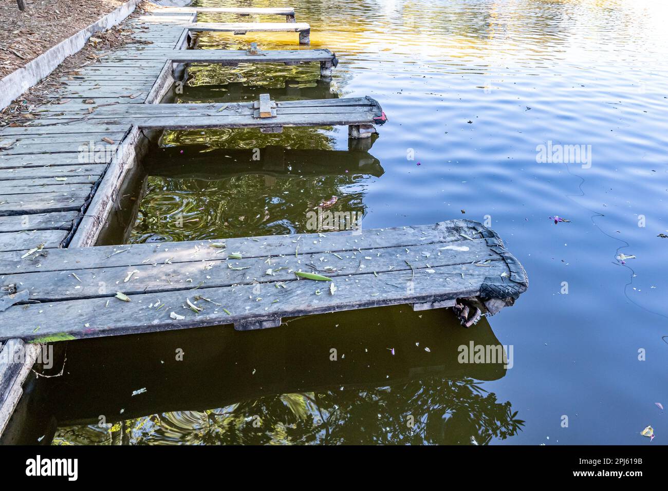 Old wooden walkway with platforms anchoring recreational rowing boats ...
