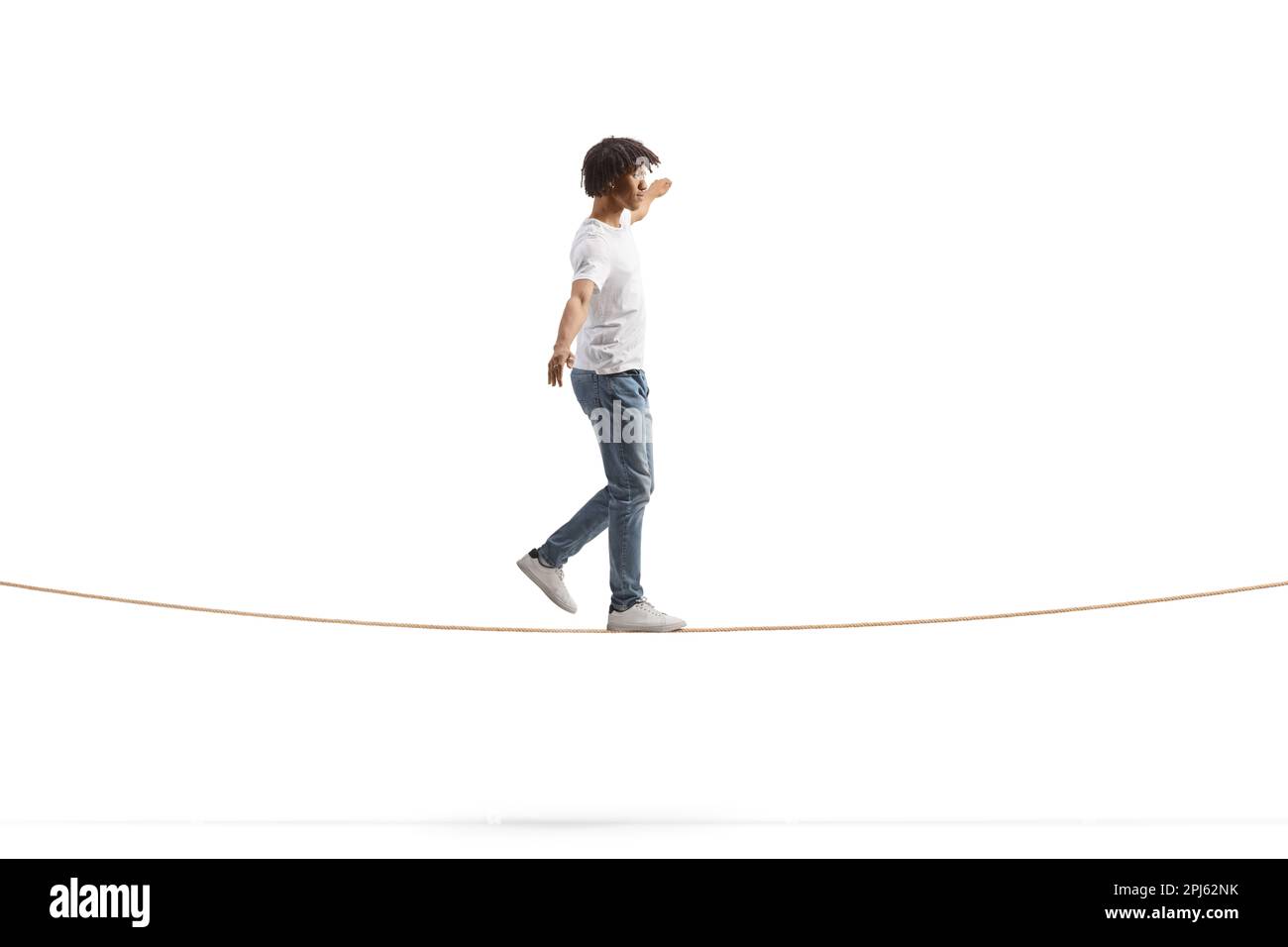 Full length profile shot of a young african american man walking on a ...