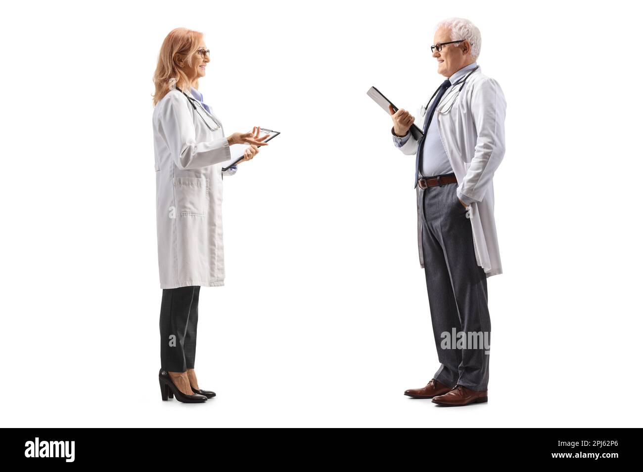 Full length profile shot of a male and female doctor standing and ...