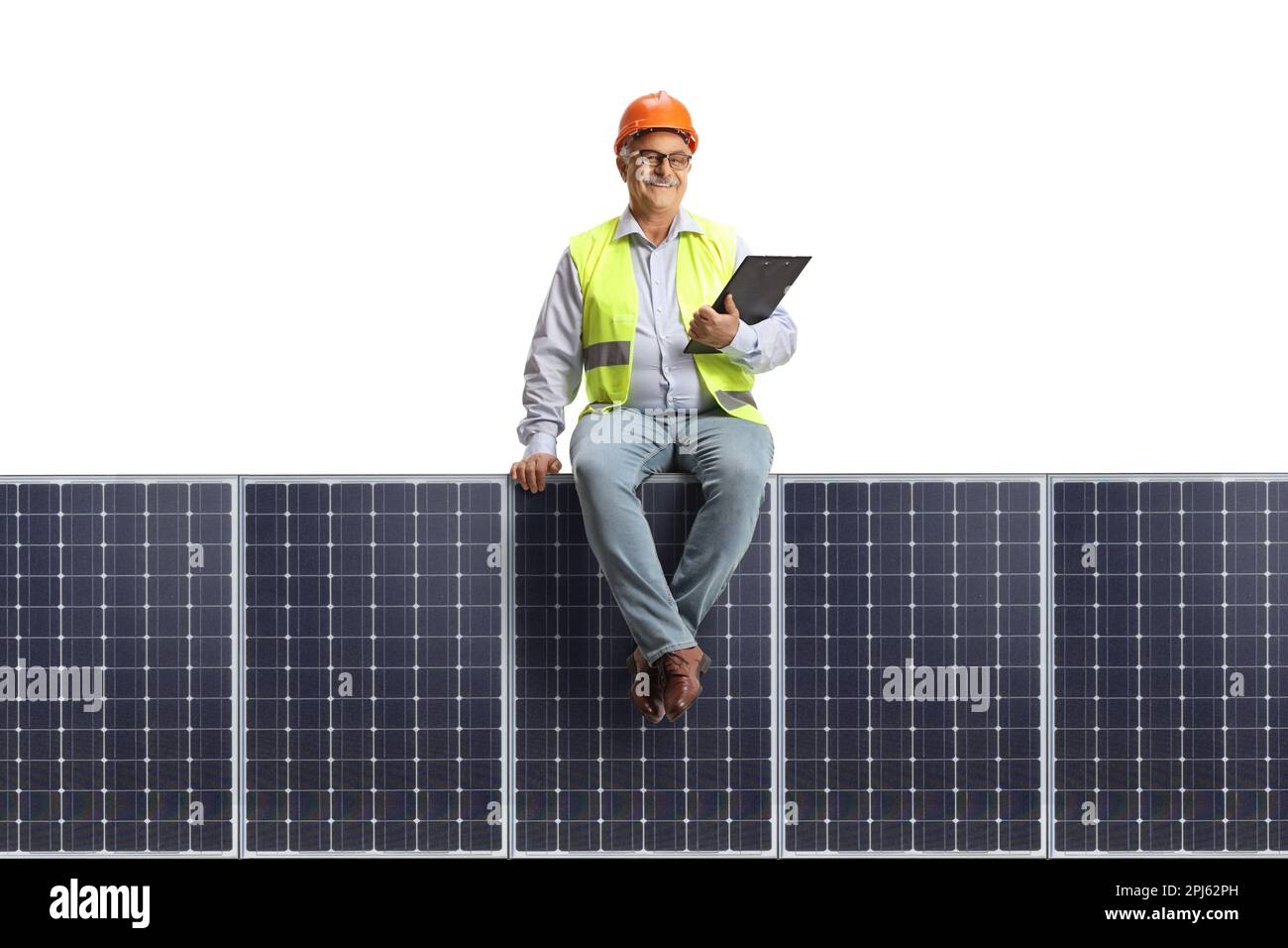 Mature male engineer wearing a safety vest and helmet and sitting on ...
