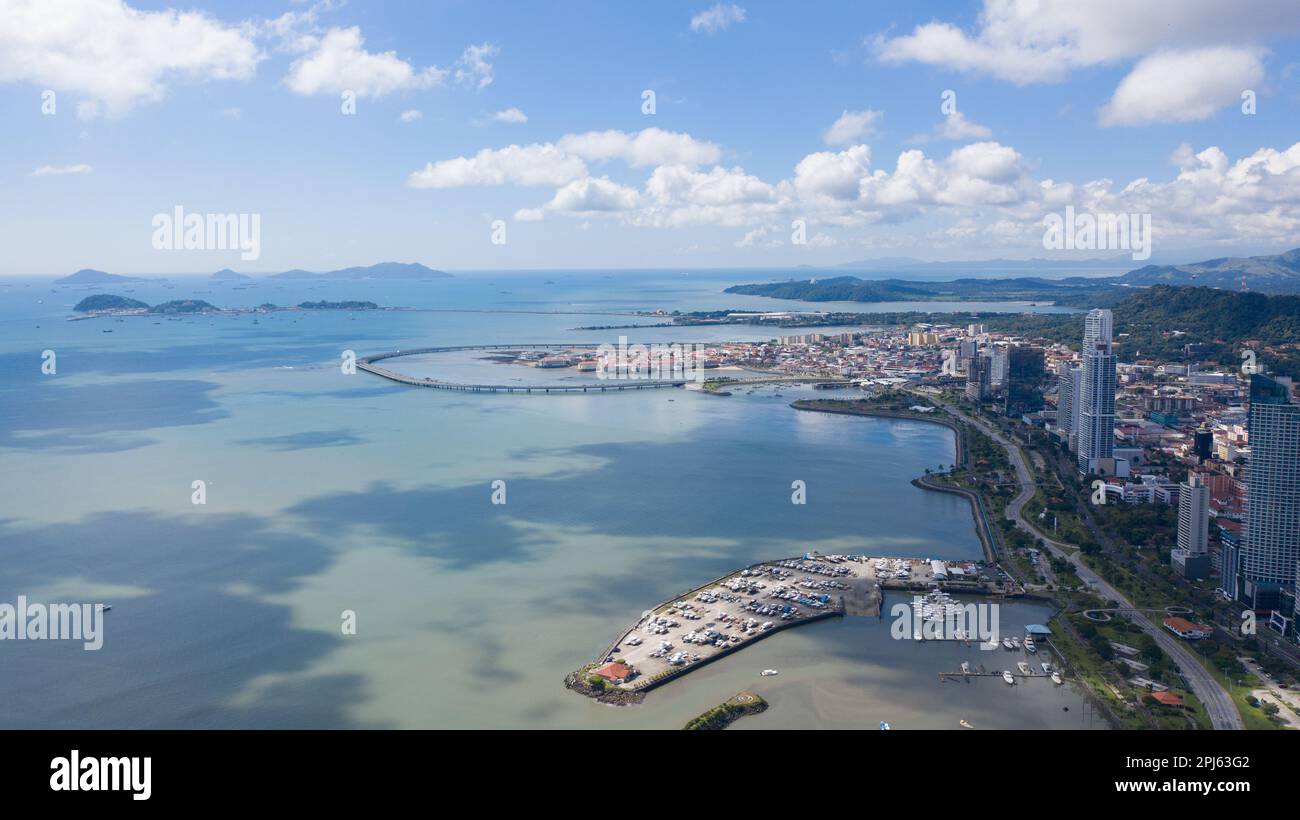 An aerial view of a harbor and modern high-rise buildings across the ...