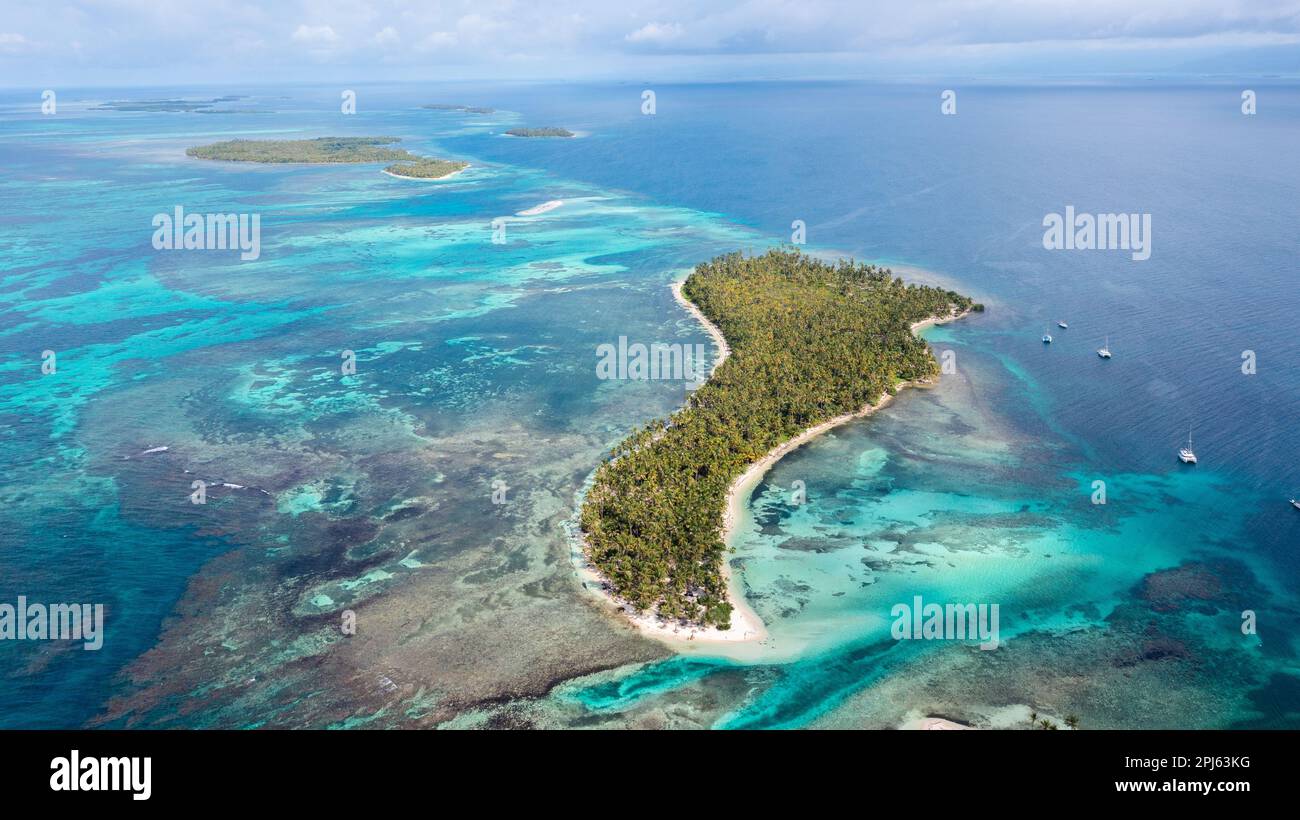 An aerial view of a stunning tropical island with a unique shape ...