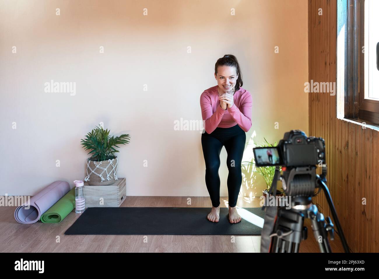 Workout instructor recording fitness vlog Stock Photo - Alamy