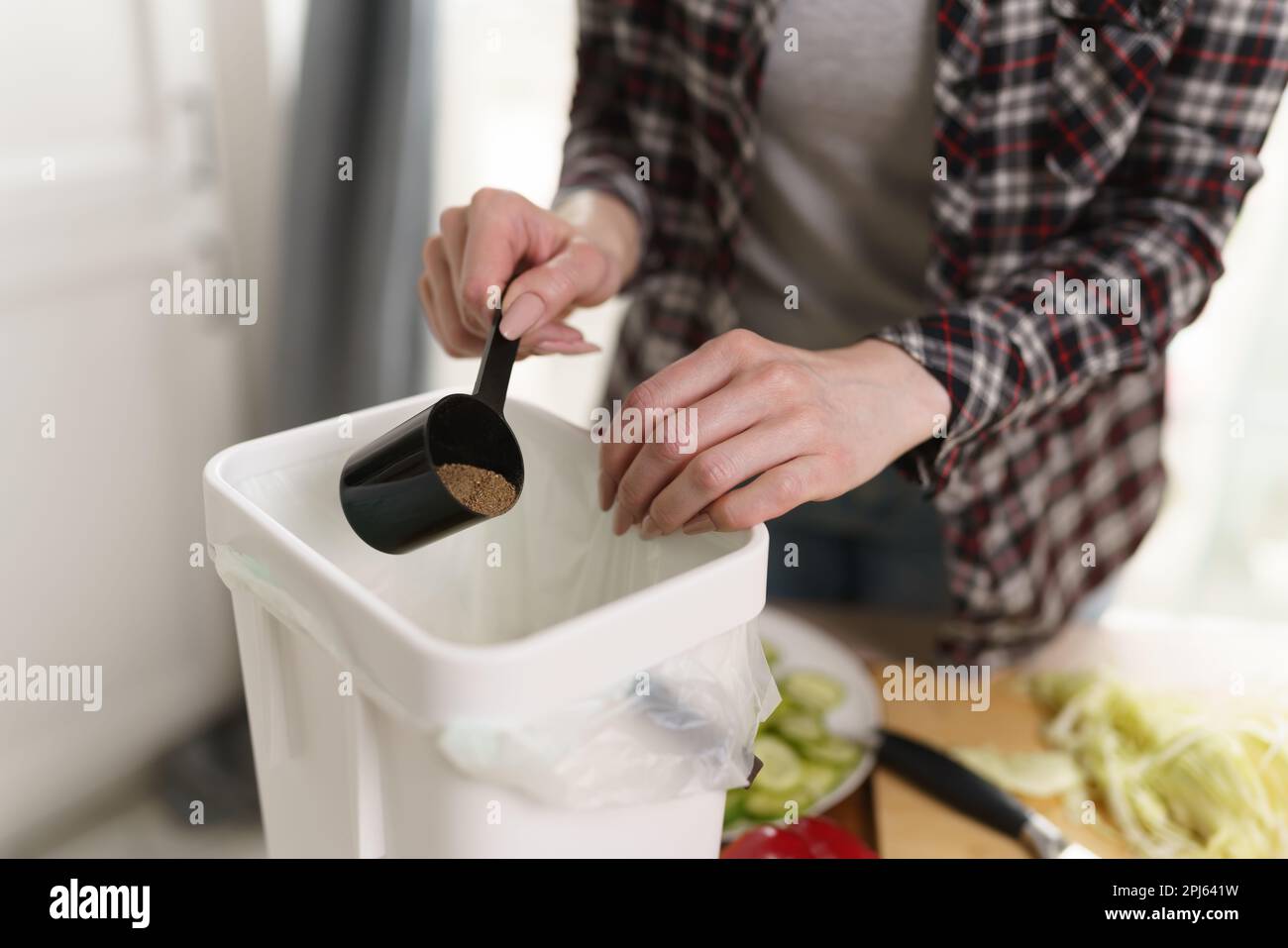 Woman pouring bokashi ferment in a compost bin. Female person ...