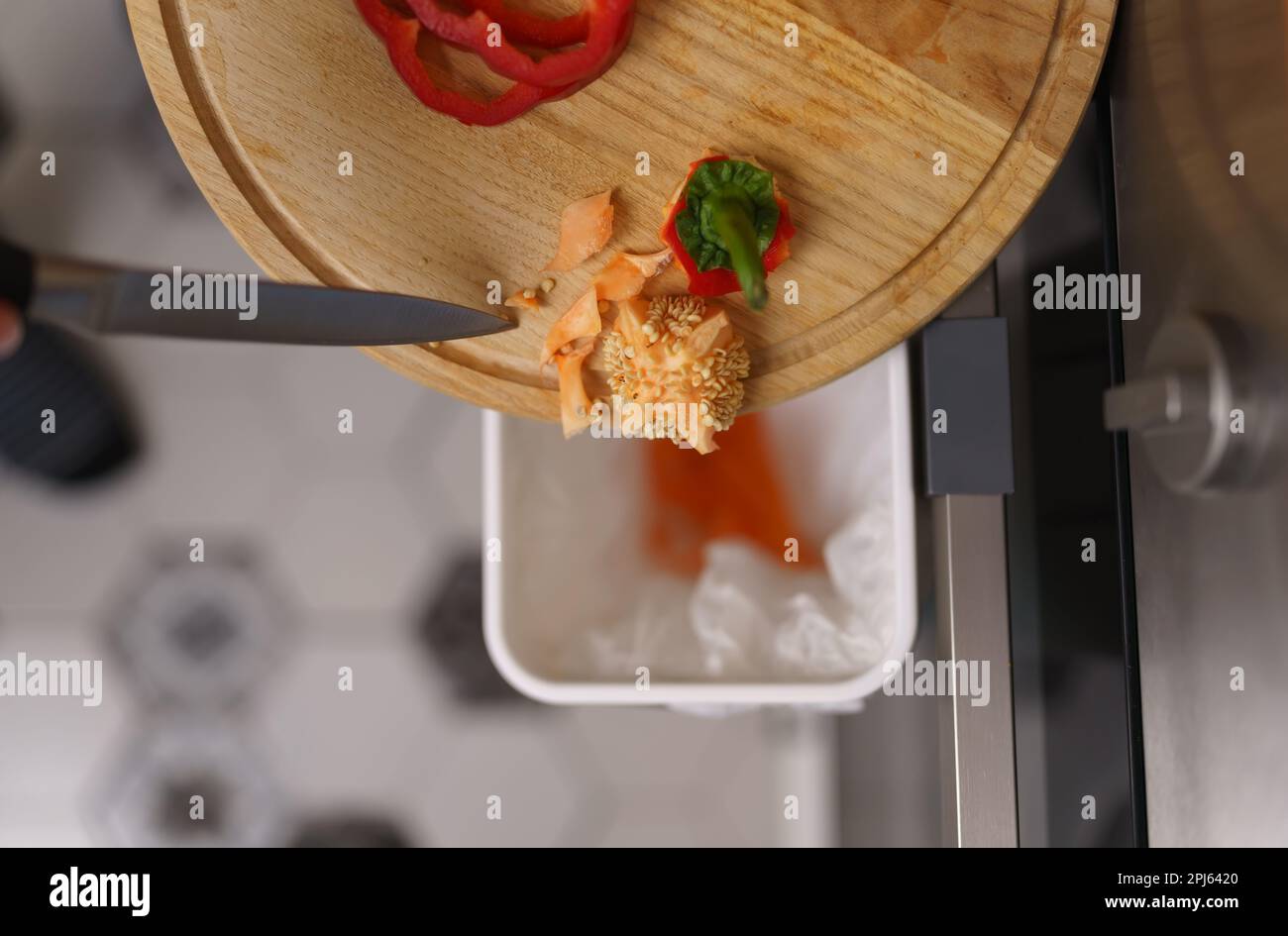 The cook throwing compostable food waste in a bokashi bin for recycling ...