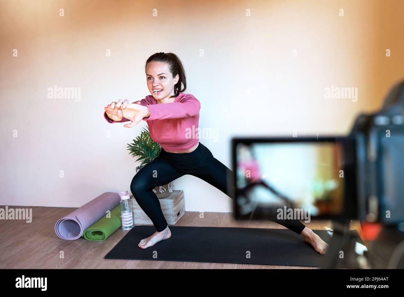 Female sportsperson recording video of fitness exercise using her ...