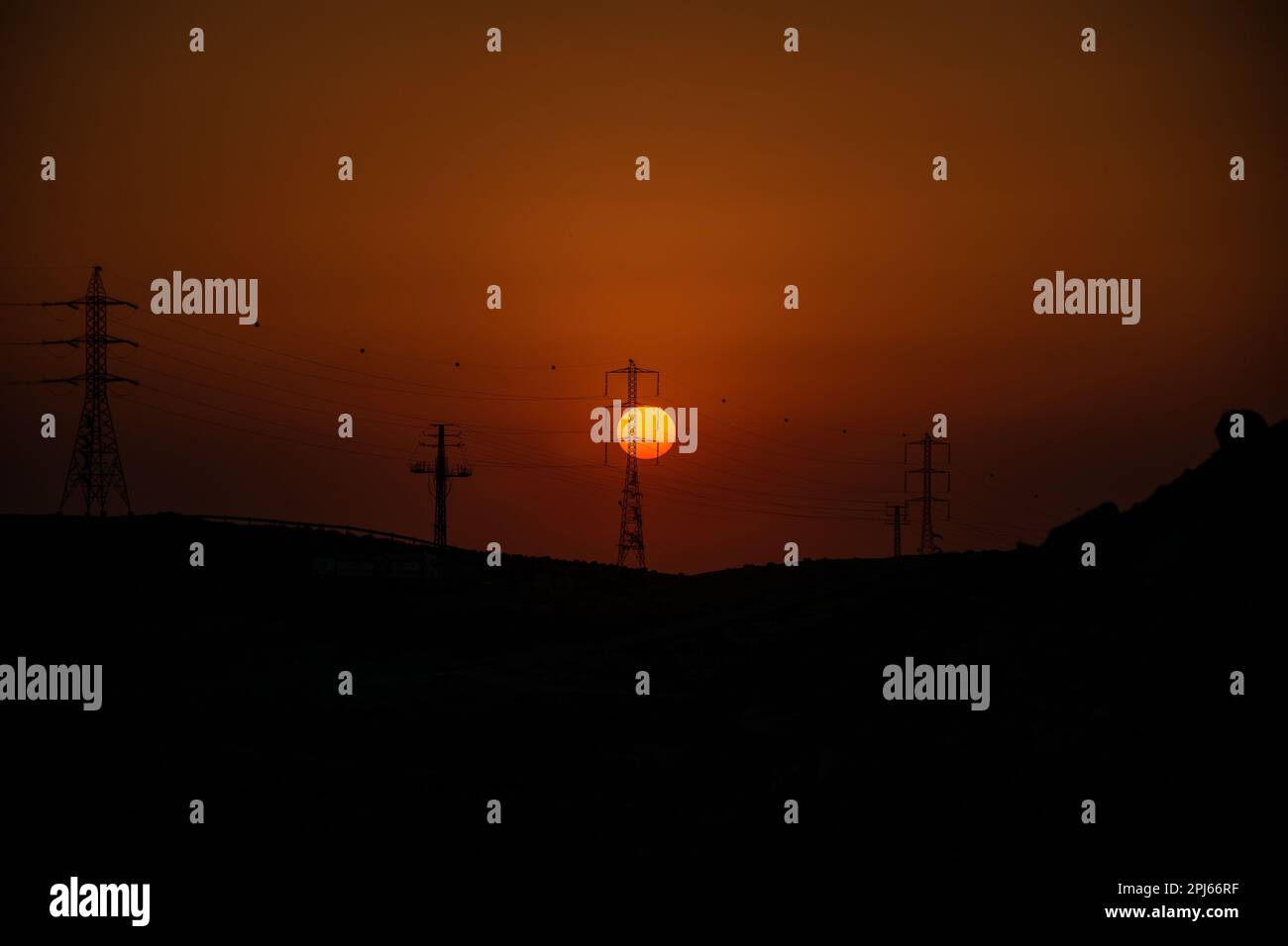 A stunning sunset illuminating a vast array of power towers and ...