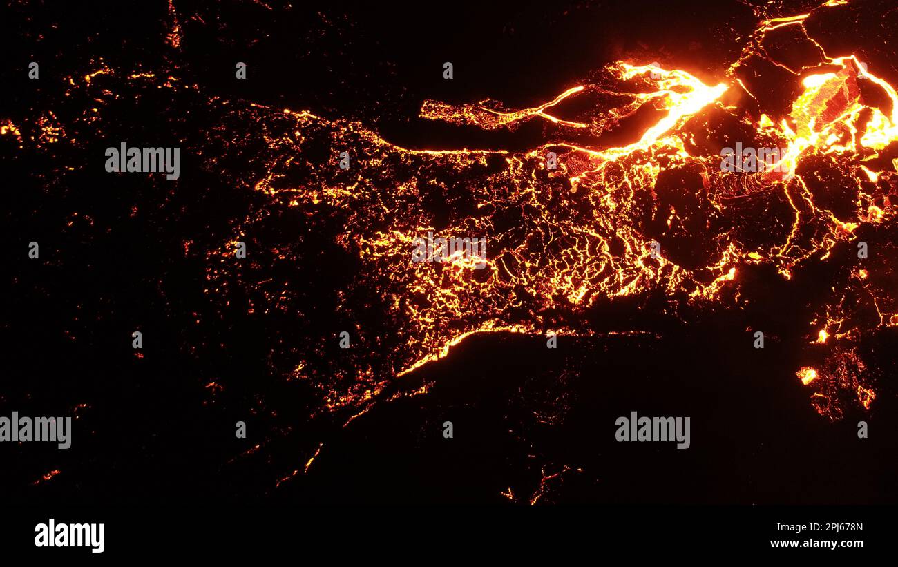 A volcanic eruption with glowing orange lava flow surrounded by a pool ...