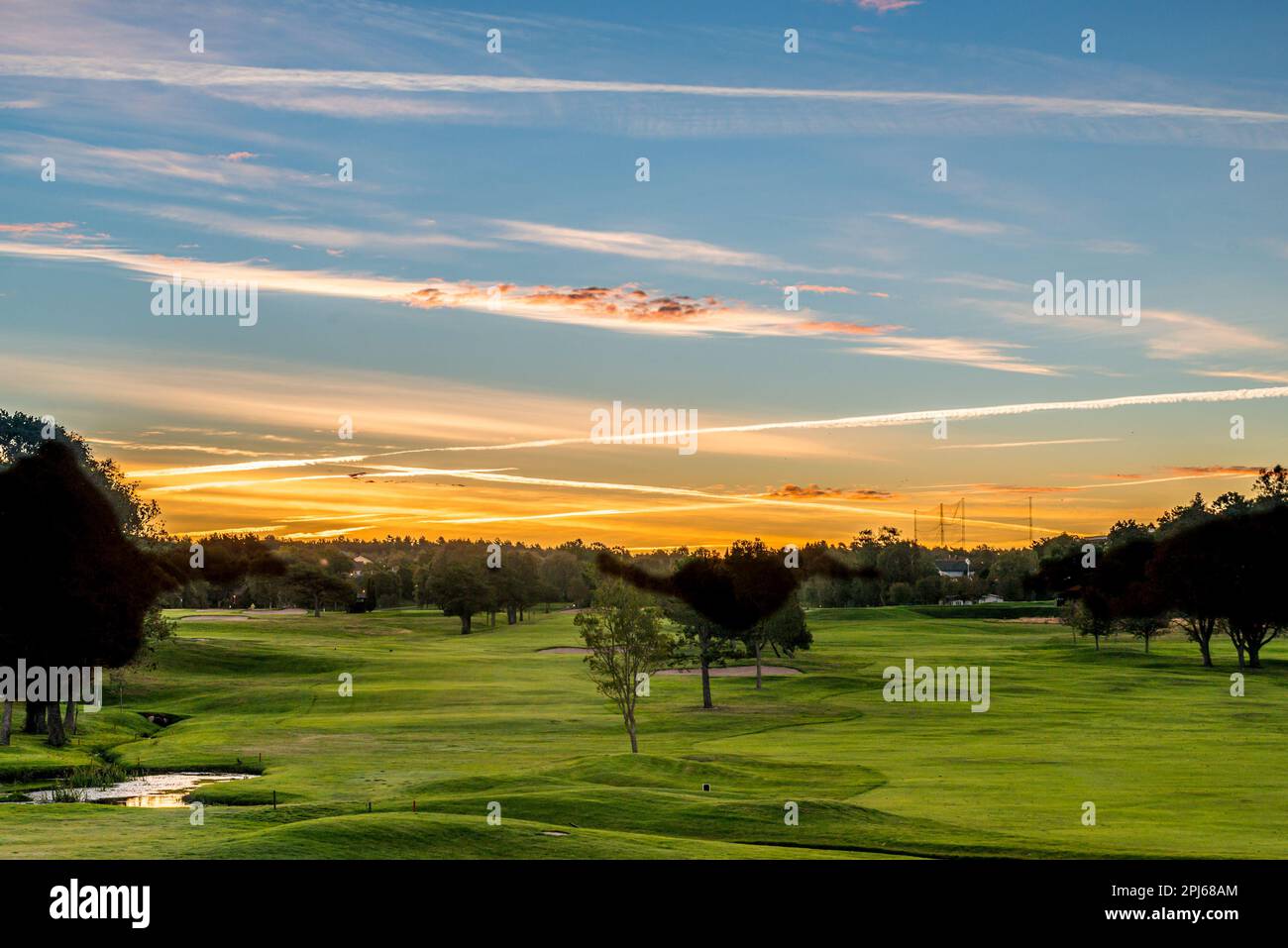 Colorful sunrise at a golf course Stock Photo - Alamy