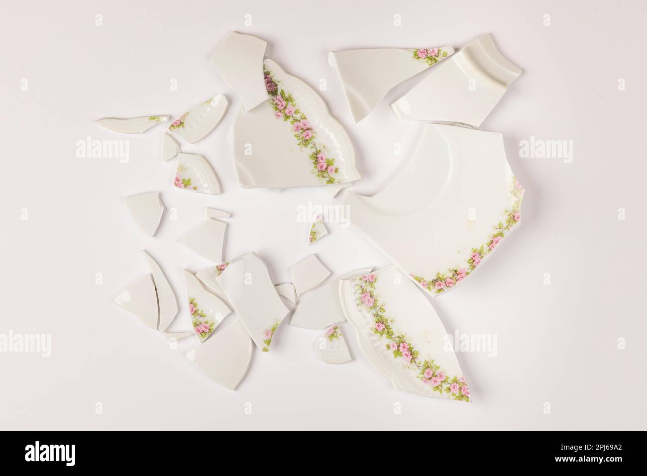 Old broken plate, pile of broken pieces, white background Stock Photo ...