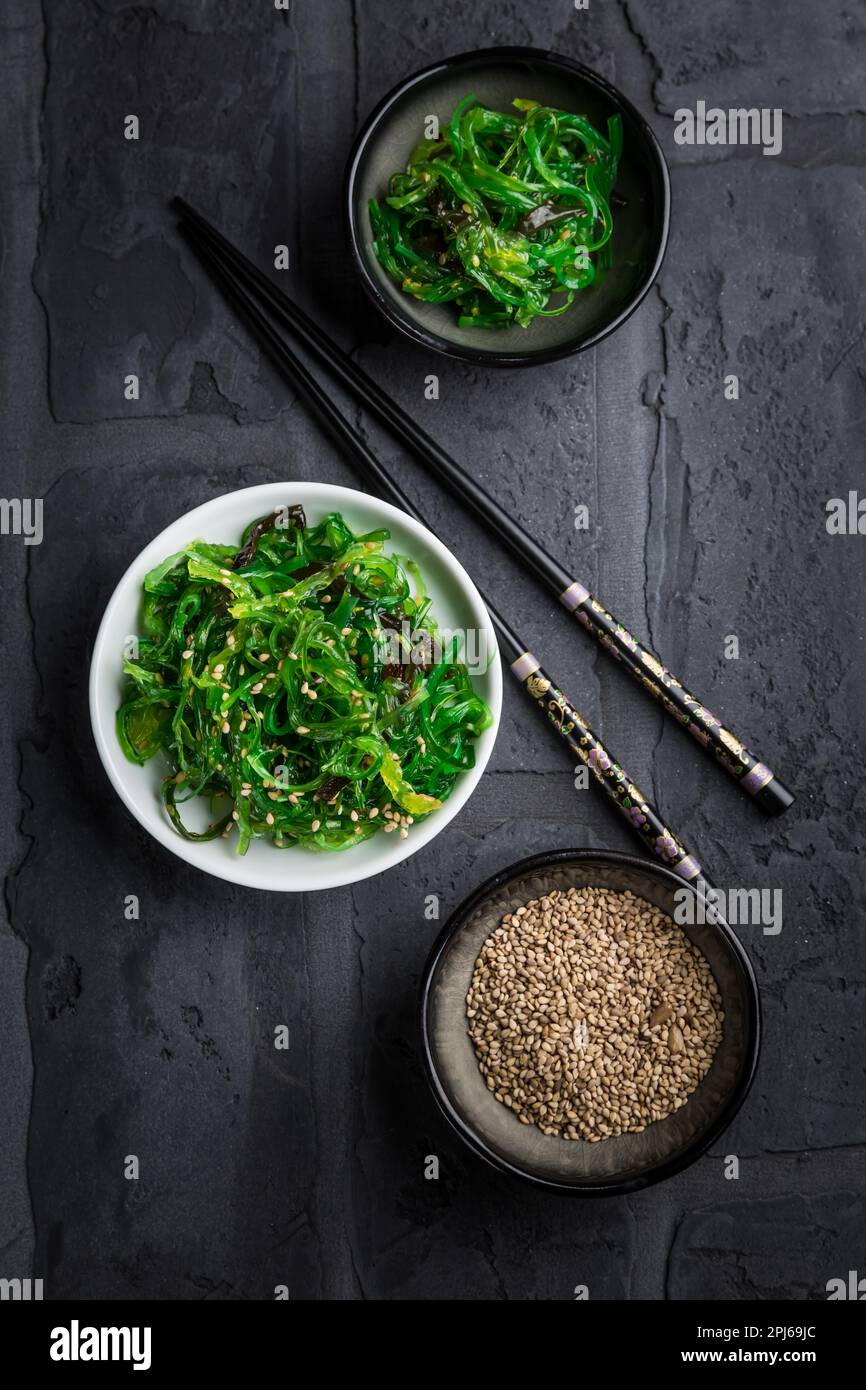 Traditional Japanese wakame salad with sesame seeds on black background ...