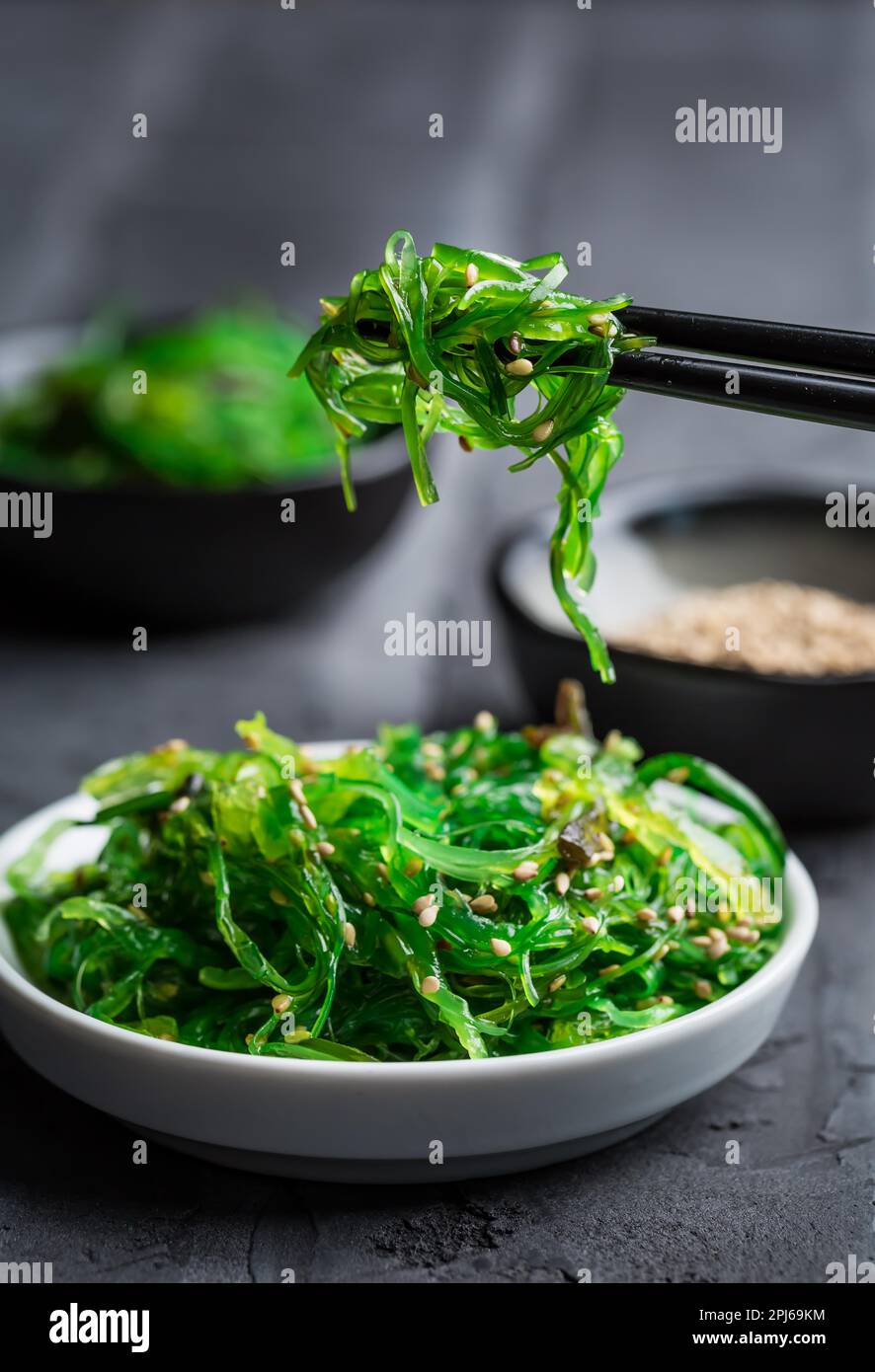 Traditional Japanese wakame salad with sesame seeds on black background ...