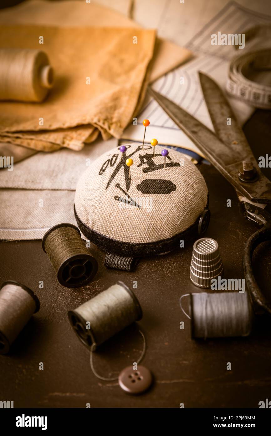 Sewing and craft tools - old scissors, bobbins with thread and needles ...