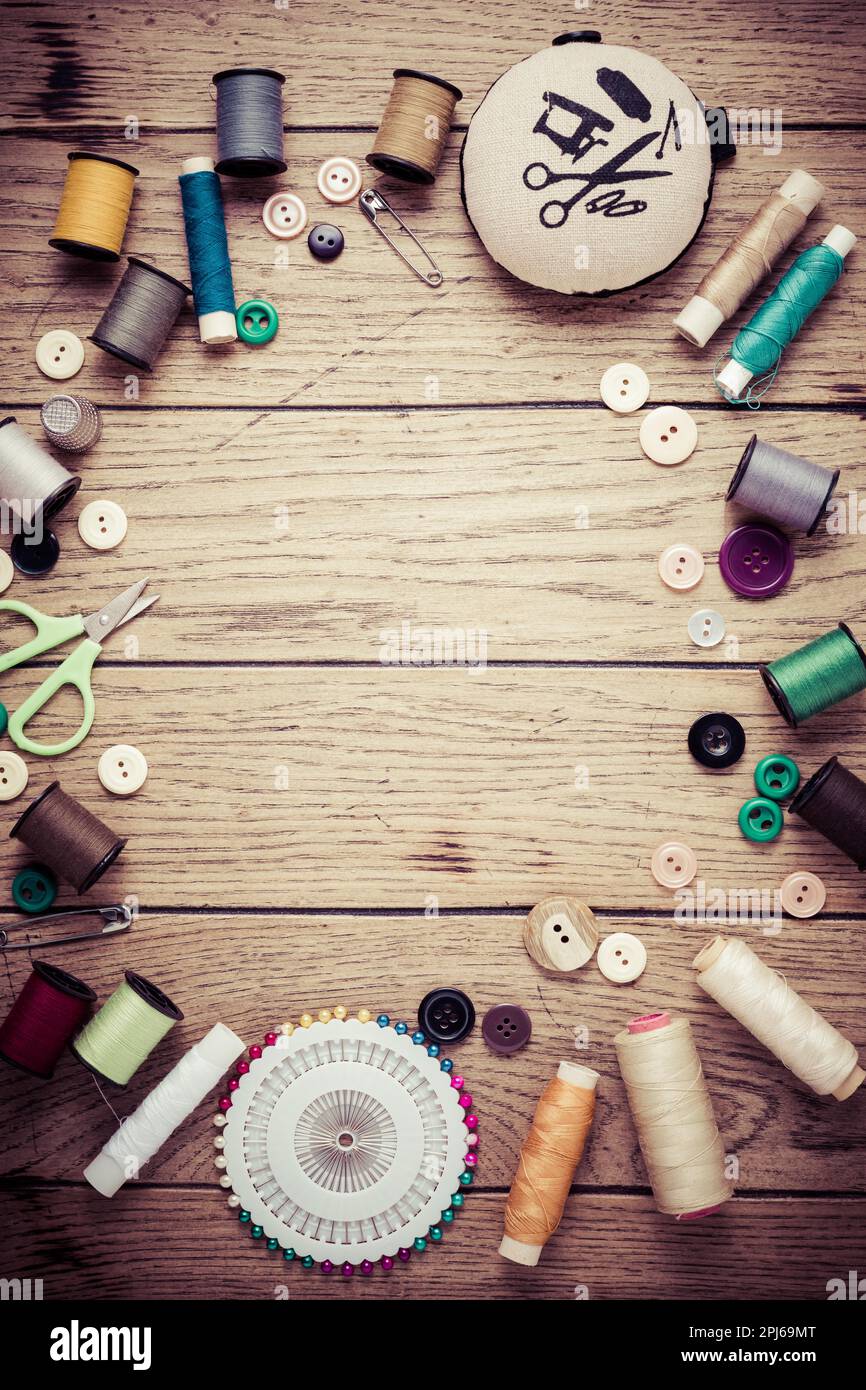 Sewing and craft tools - threads and buttons on wooden background in ...