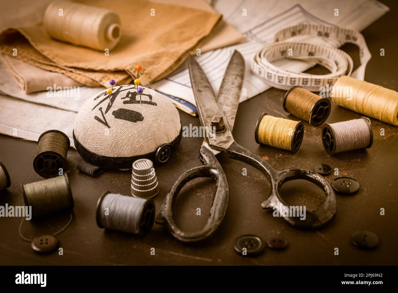 Sewing and craft tools - old scissors, bobbins with thread and needles ...
