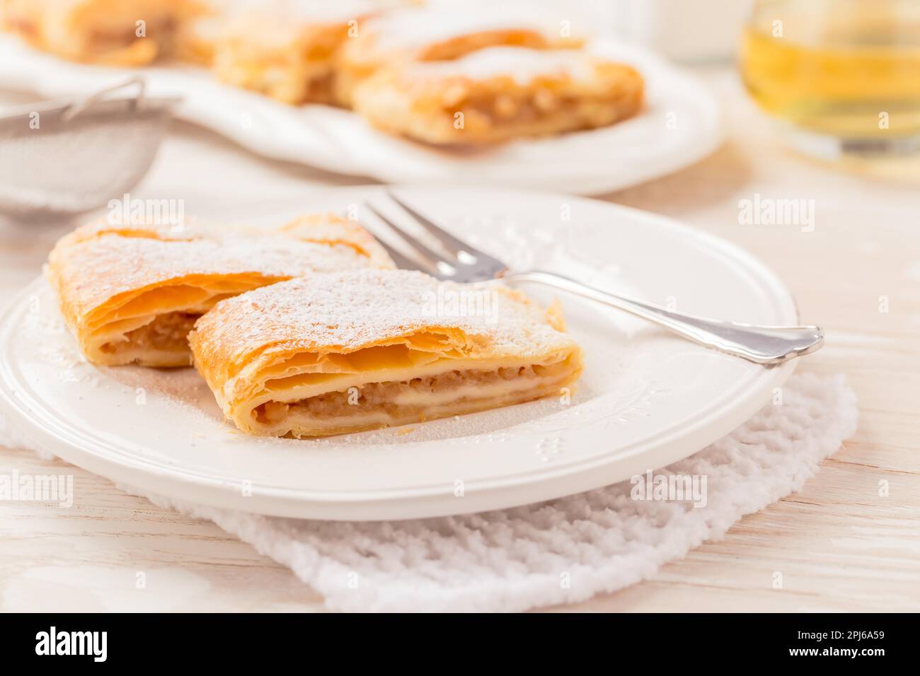 Homemade apple strudel (apfelstrudel) on white plate. Popular pastry ...