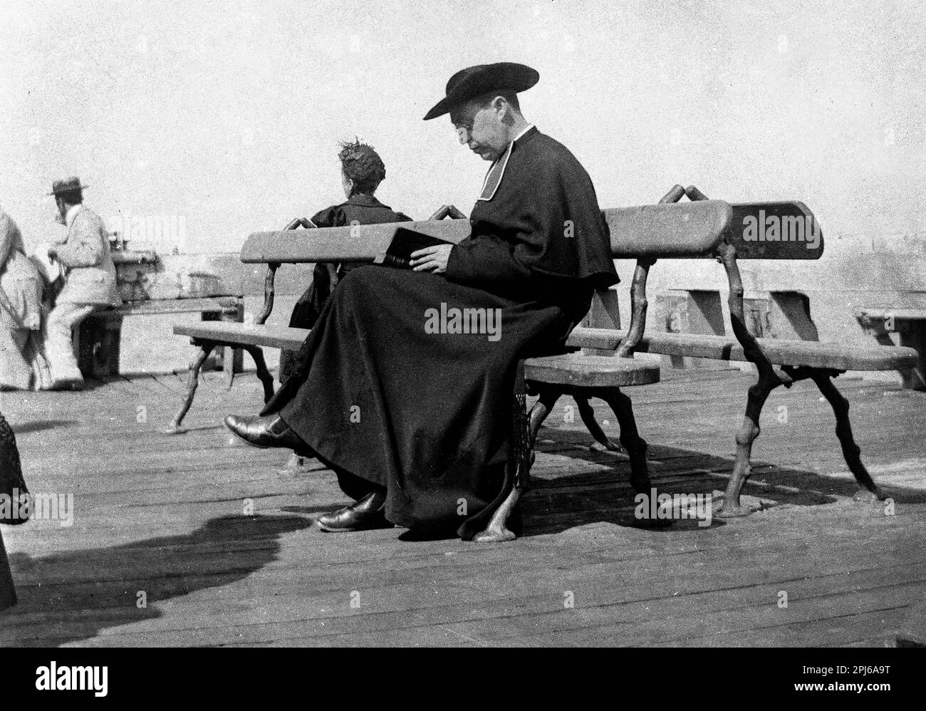 Catholic priest wearing cassock and Saturno hat reading book bible in ...