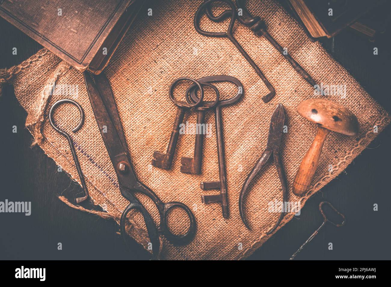 Old tools, books, keys and supplies on burlap in vintage style Stock ...