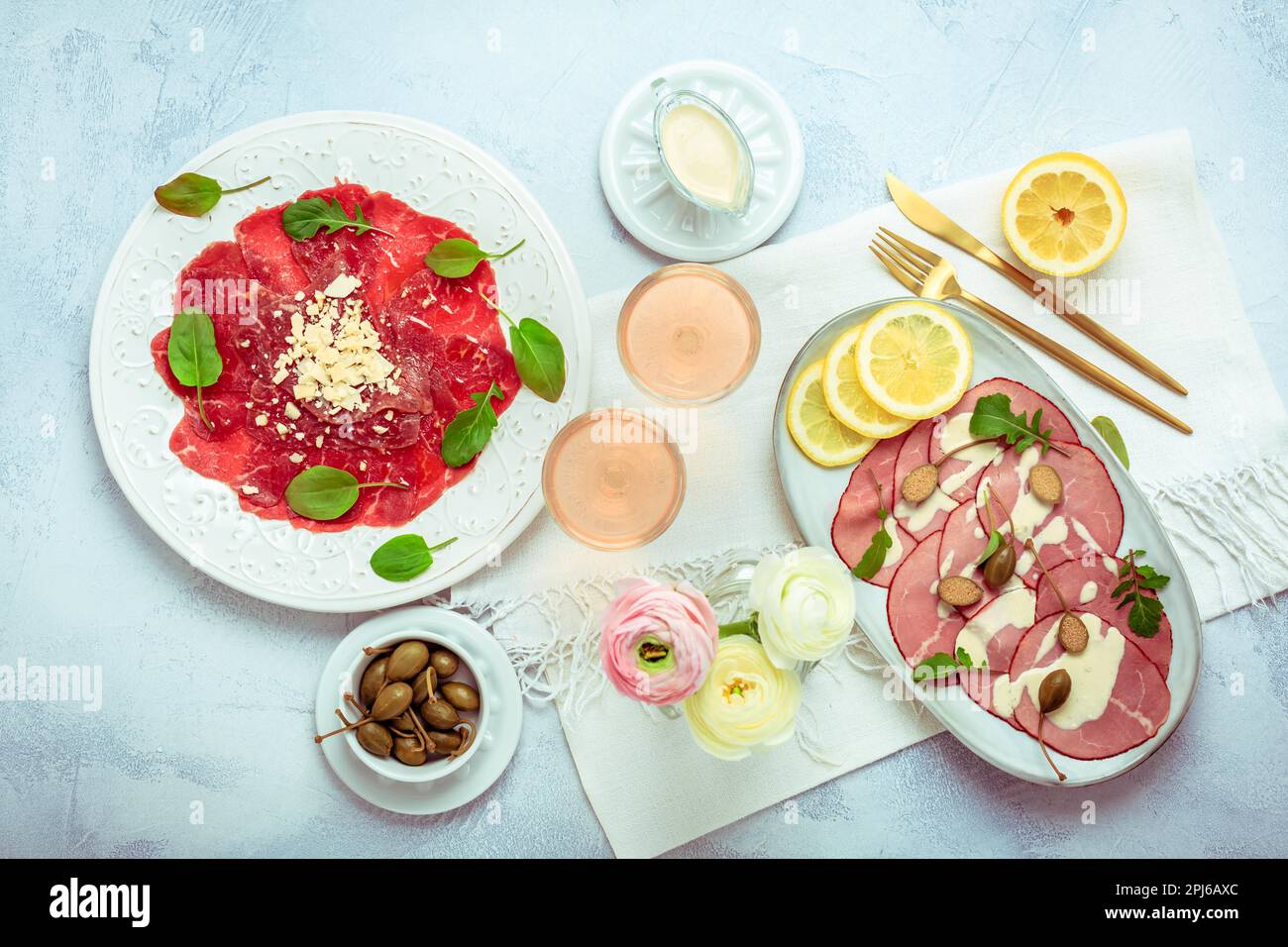 Appetizers - Vitello tonnato and beef Carpaccio with two glasses of ...
