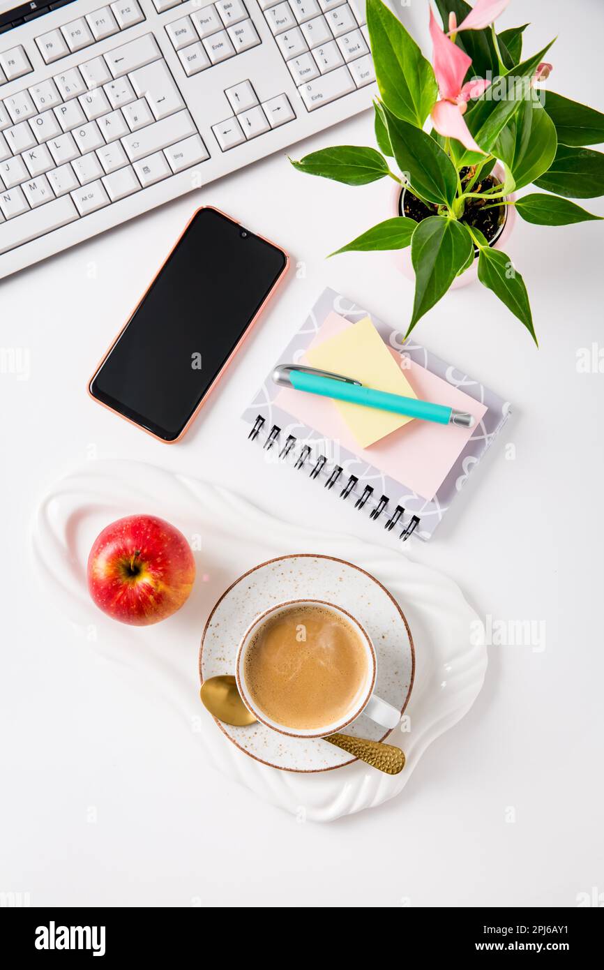 Workplace and office desk with coffee, apple, laptop, headset and ...