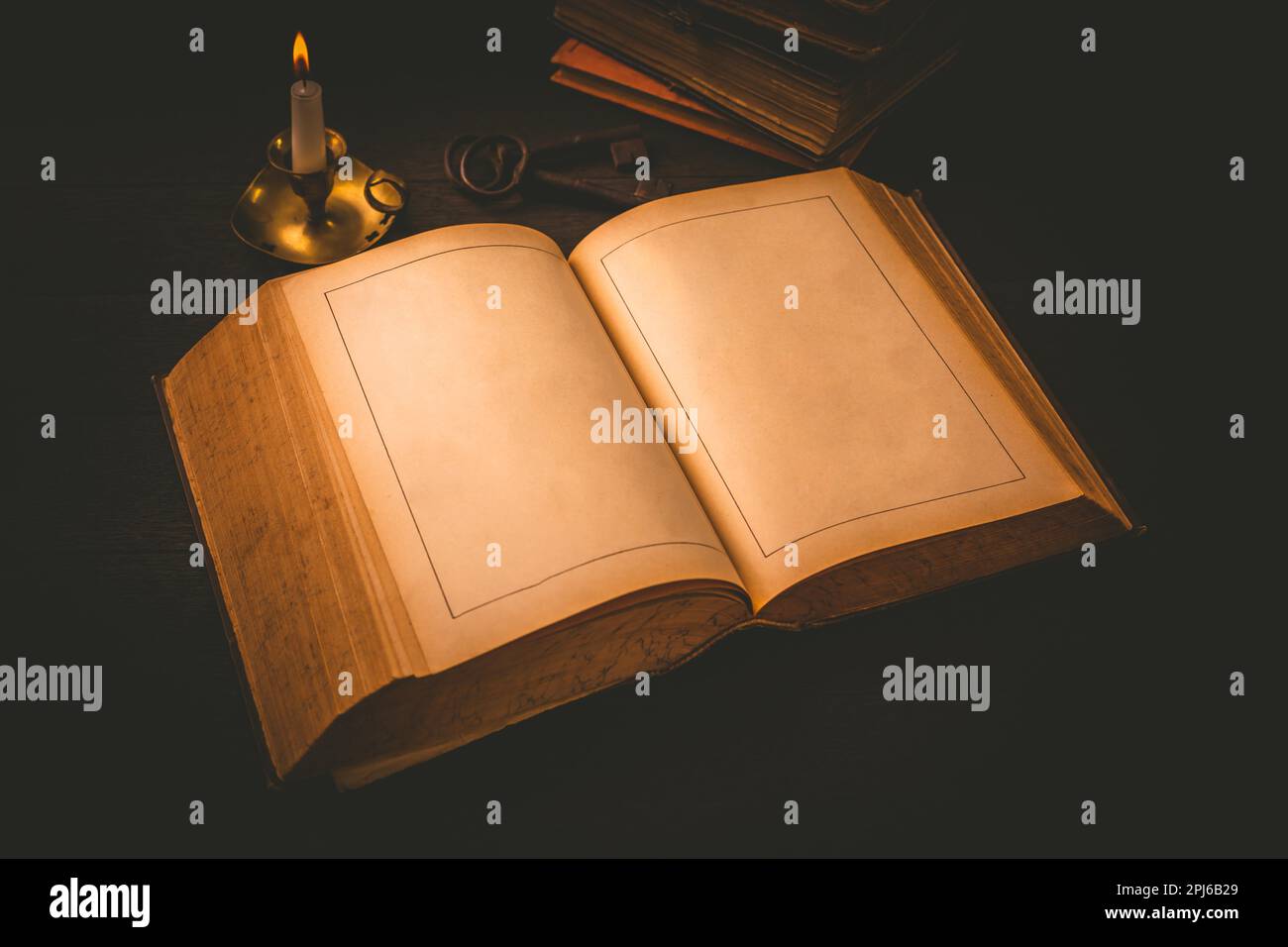 Old antique book with empty pages and candle in vintage style on black ...