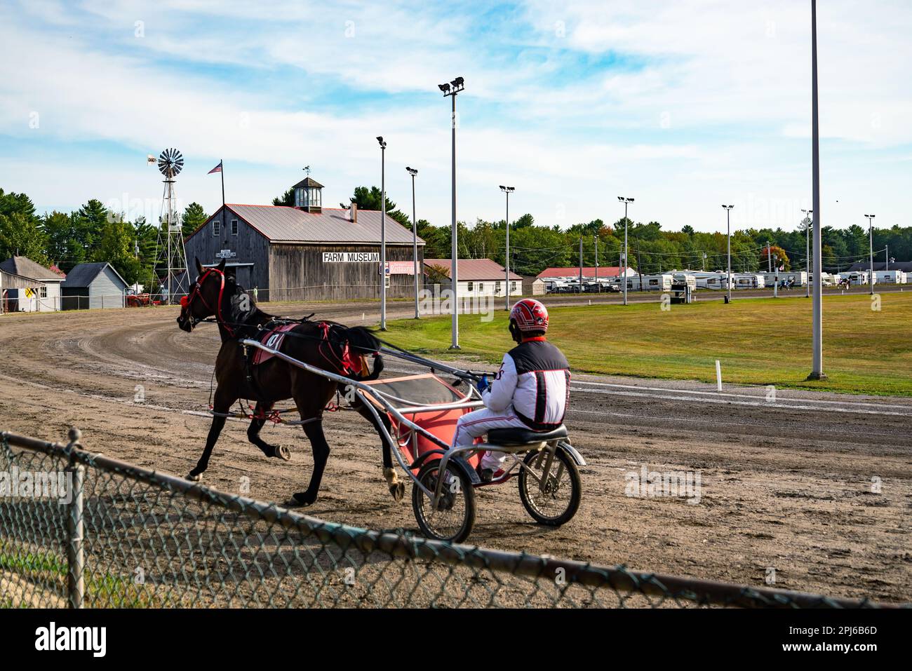 Jockey and horse. Trotting horse race. Race in harness with a sulky or ...