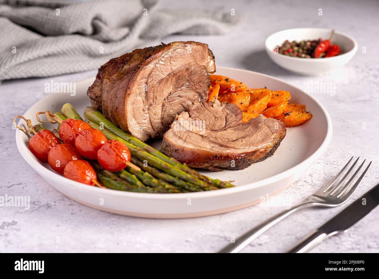 Food photography of roasted lamb, carrot, asparagus, tomato, seasoning ...